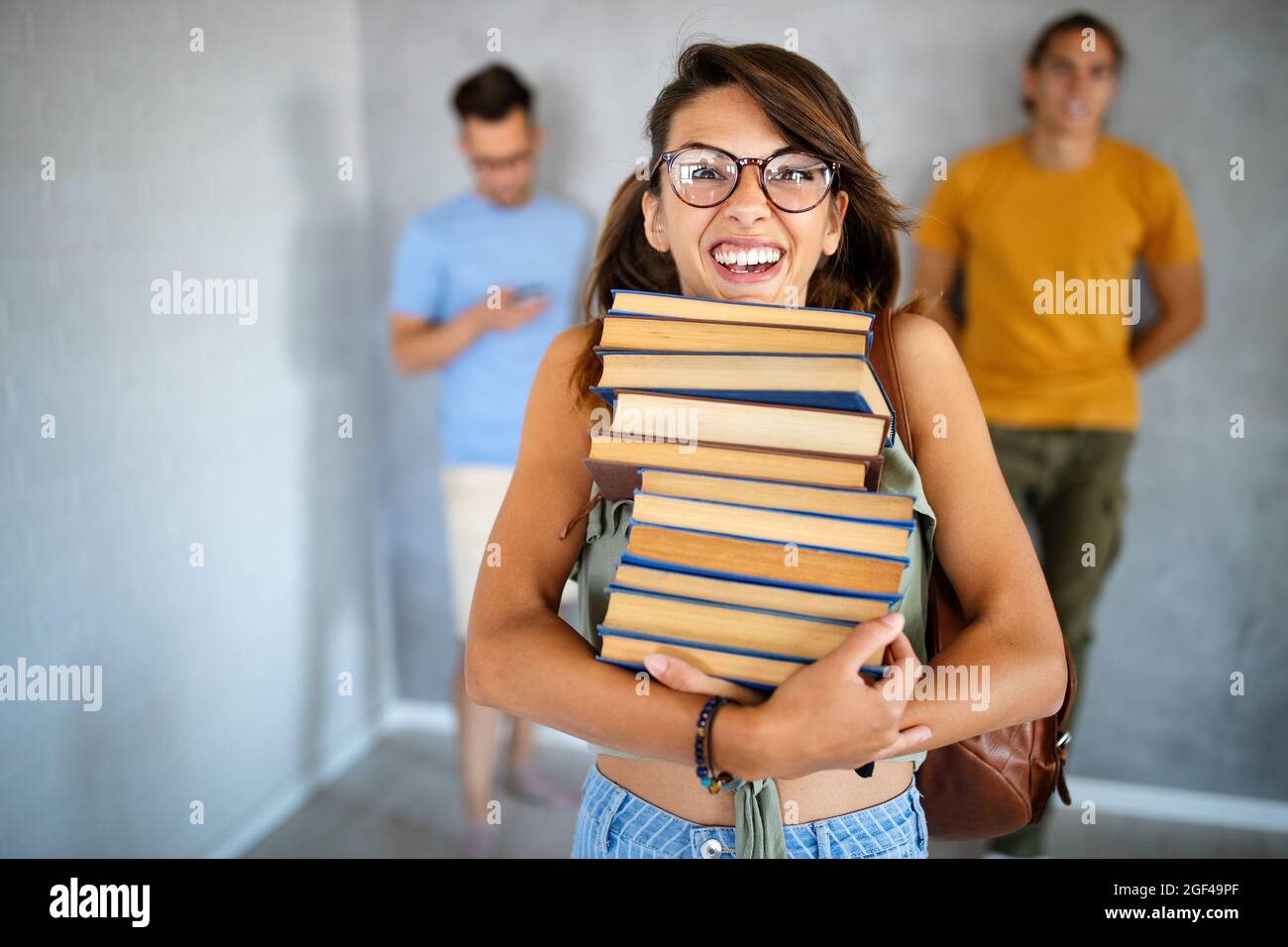 Stylish nerd girl with many books. Education, study, people, university ...