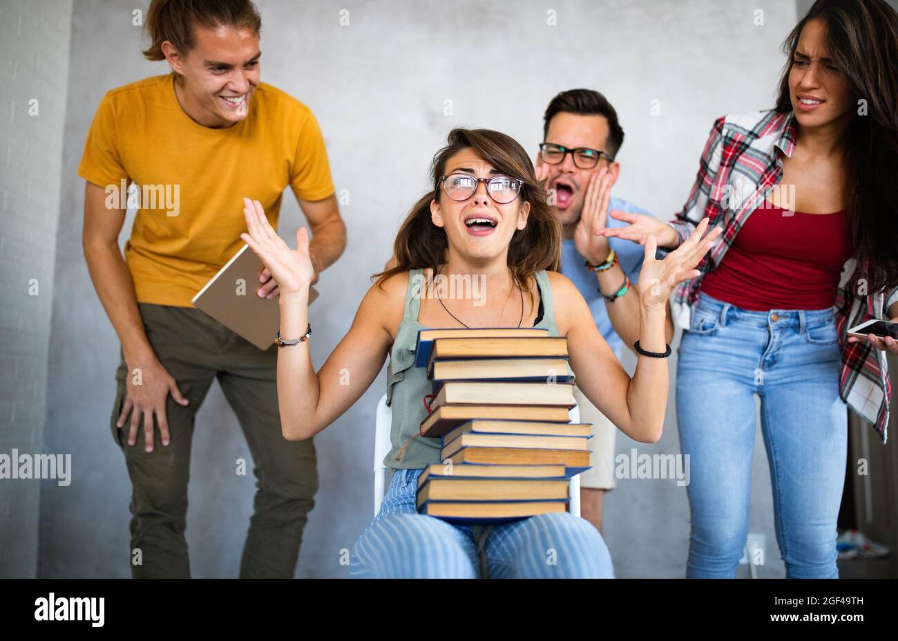 Eager student overwhelmed by studying and reading books Stock Photo - Alamy