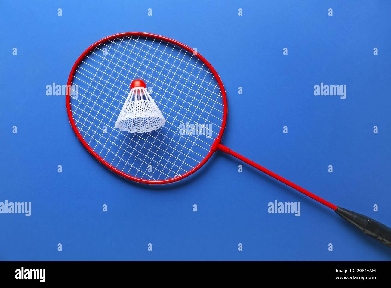 Badminton racket and shuttlecock on color background Stock Photo - Alamy