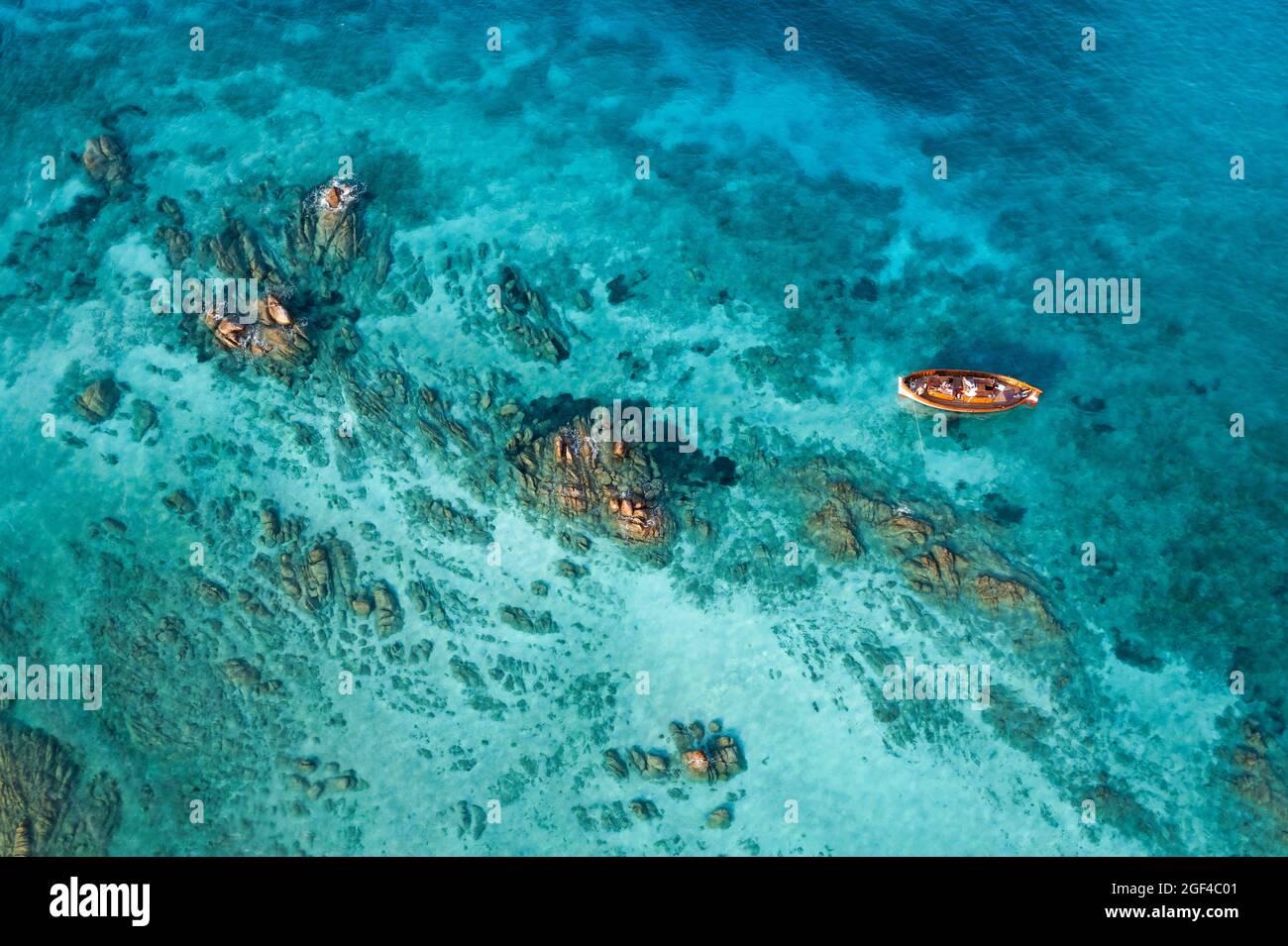 View from above, stunning aerial view of a wooden boat anchored to some ...