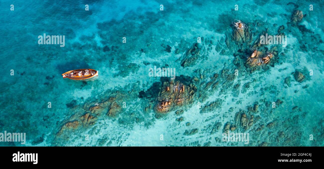 View from above, stunning aerial view of a wooden boat anchored to some ...