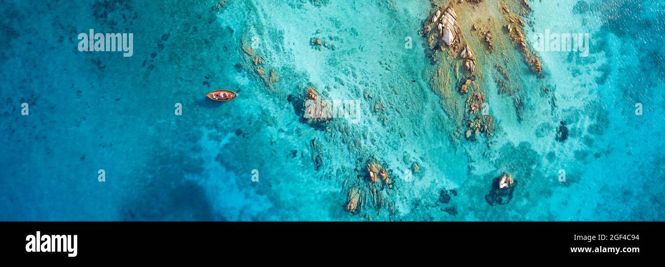 View from above, stunning aerial view of a wooden boat anchored to some ...