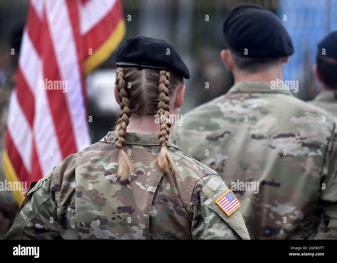 American Soldiers looks on the US flag. US Army. Military forces of the ...