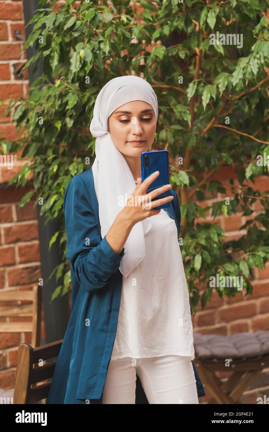 Muslim woman taking selfie. Happy beautiful girl with scarf take ...