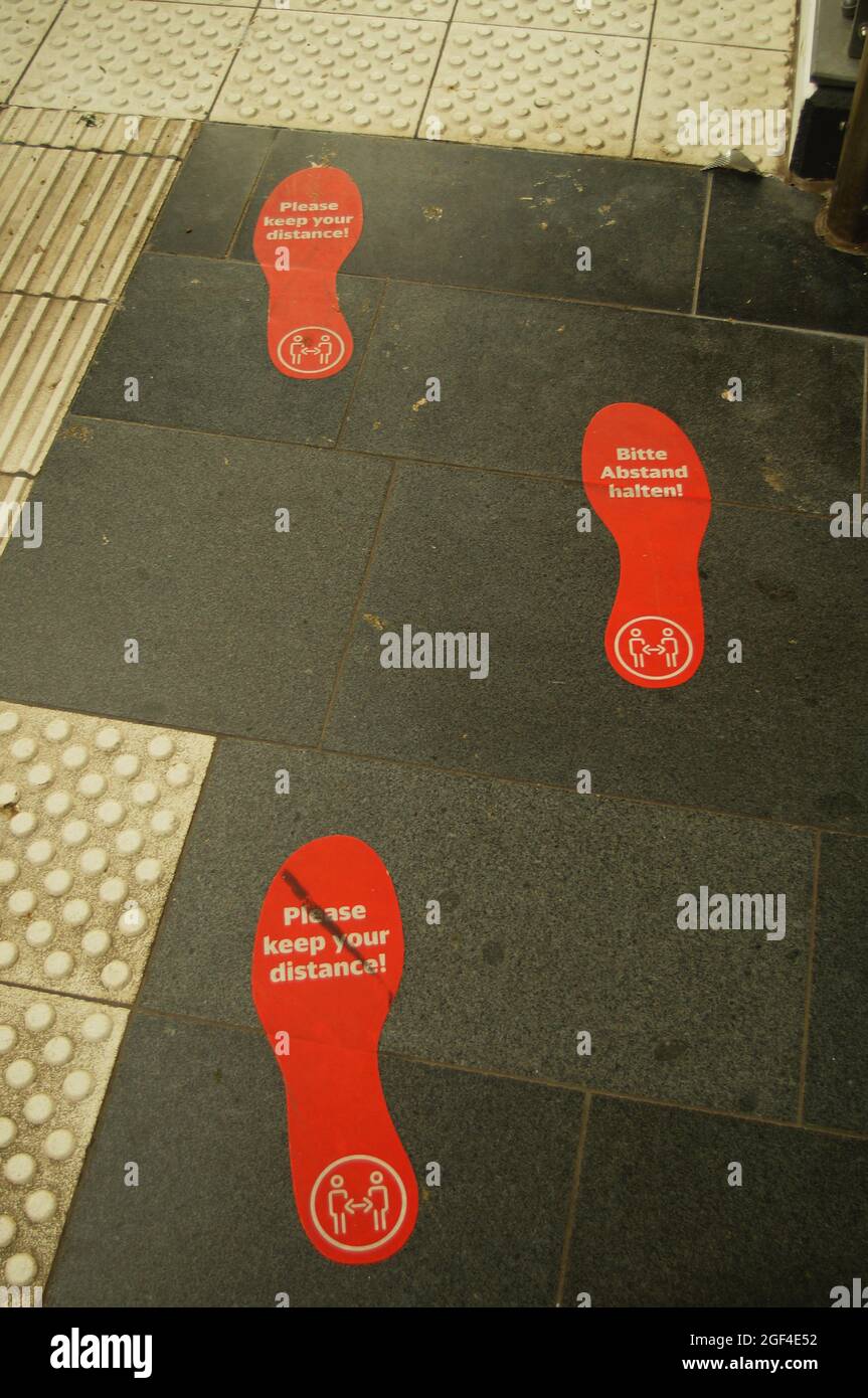 Footprint stickers are a reminder of the distance rules Stock Photo - Alamy