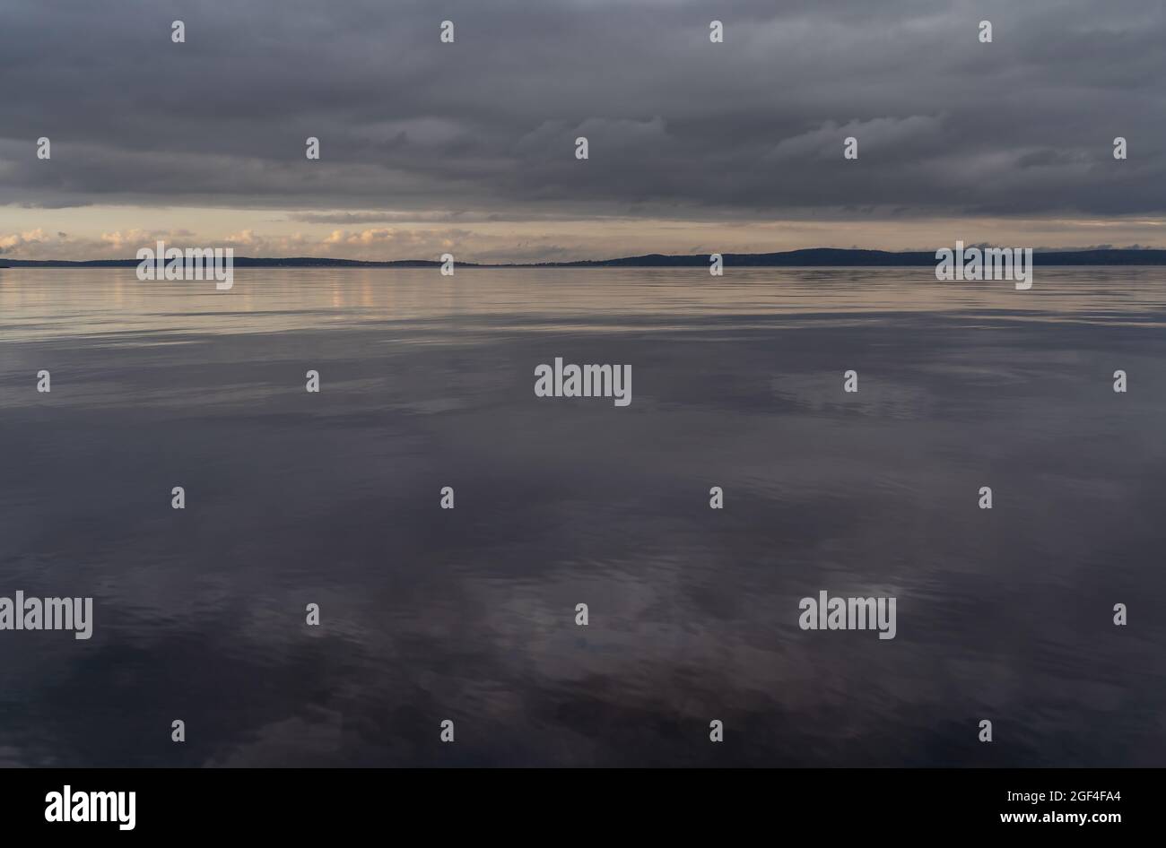 Beautiful autumn misty grey lake and cloudy sky reflection in the water ...