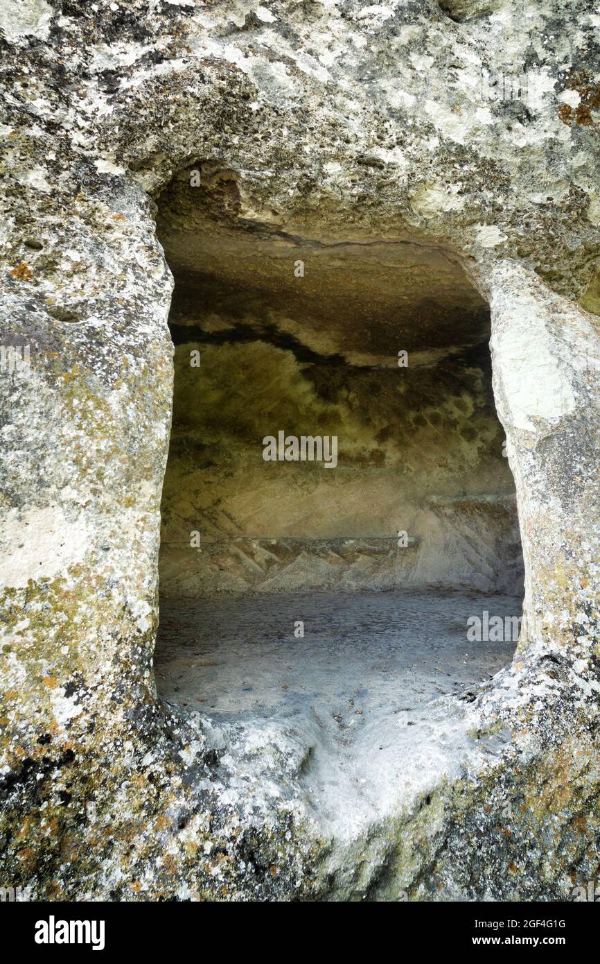 Entrance to a man-made cave in a limestone rock. A place of refuge for ...