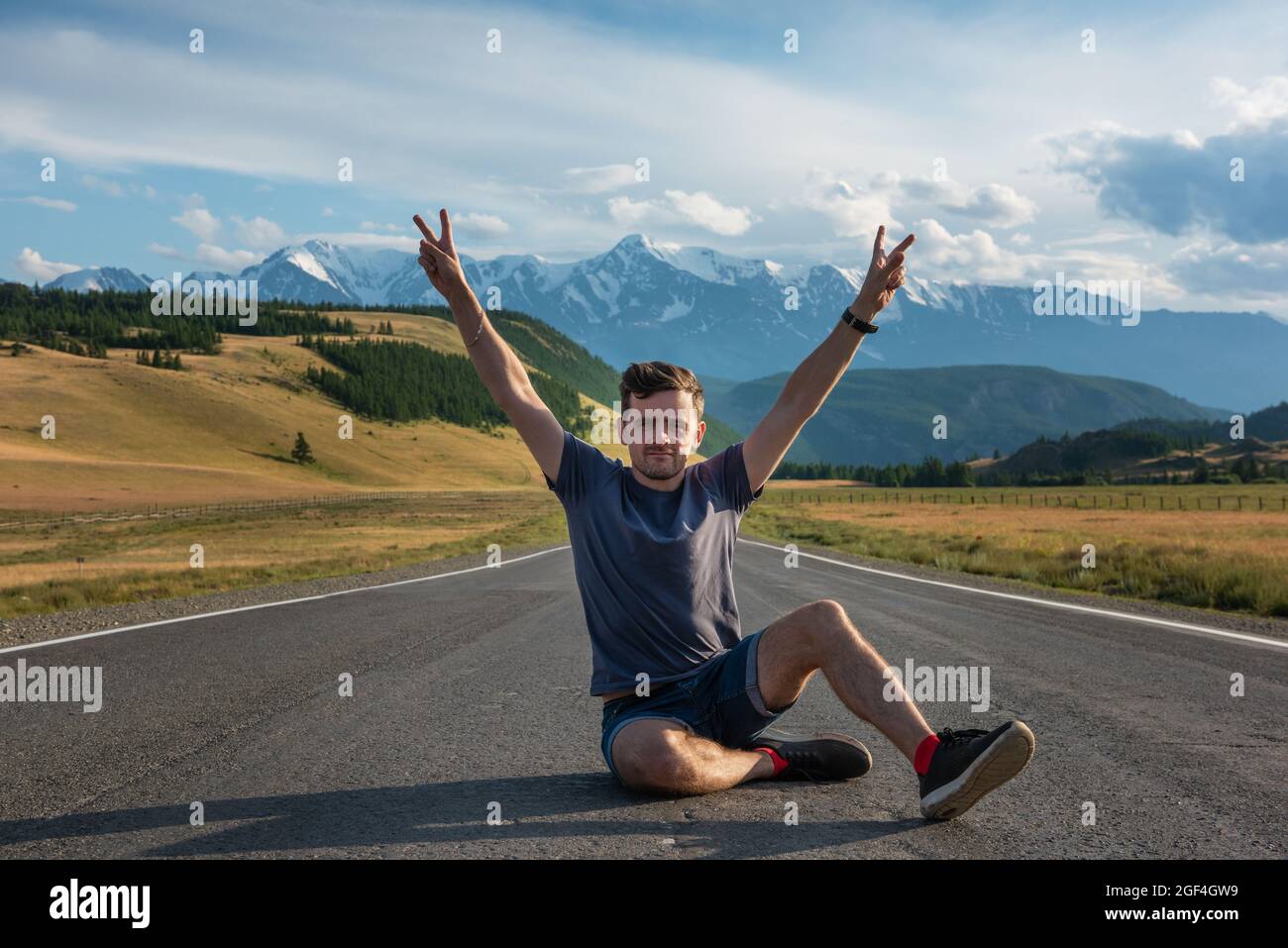 Man on the Chuysky trakt road in the Altai mountains. One of the most ...