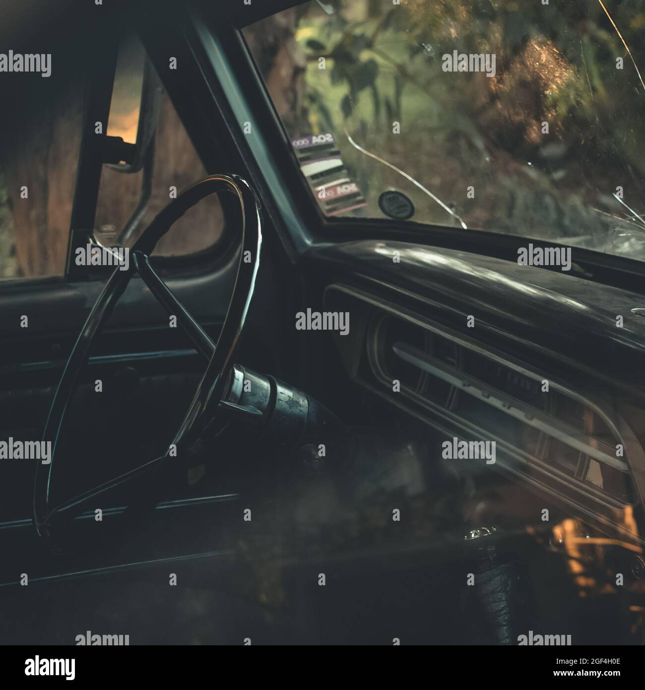 Closeup view from inside of a vintage car with a broken windshield ...