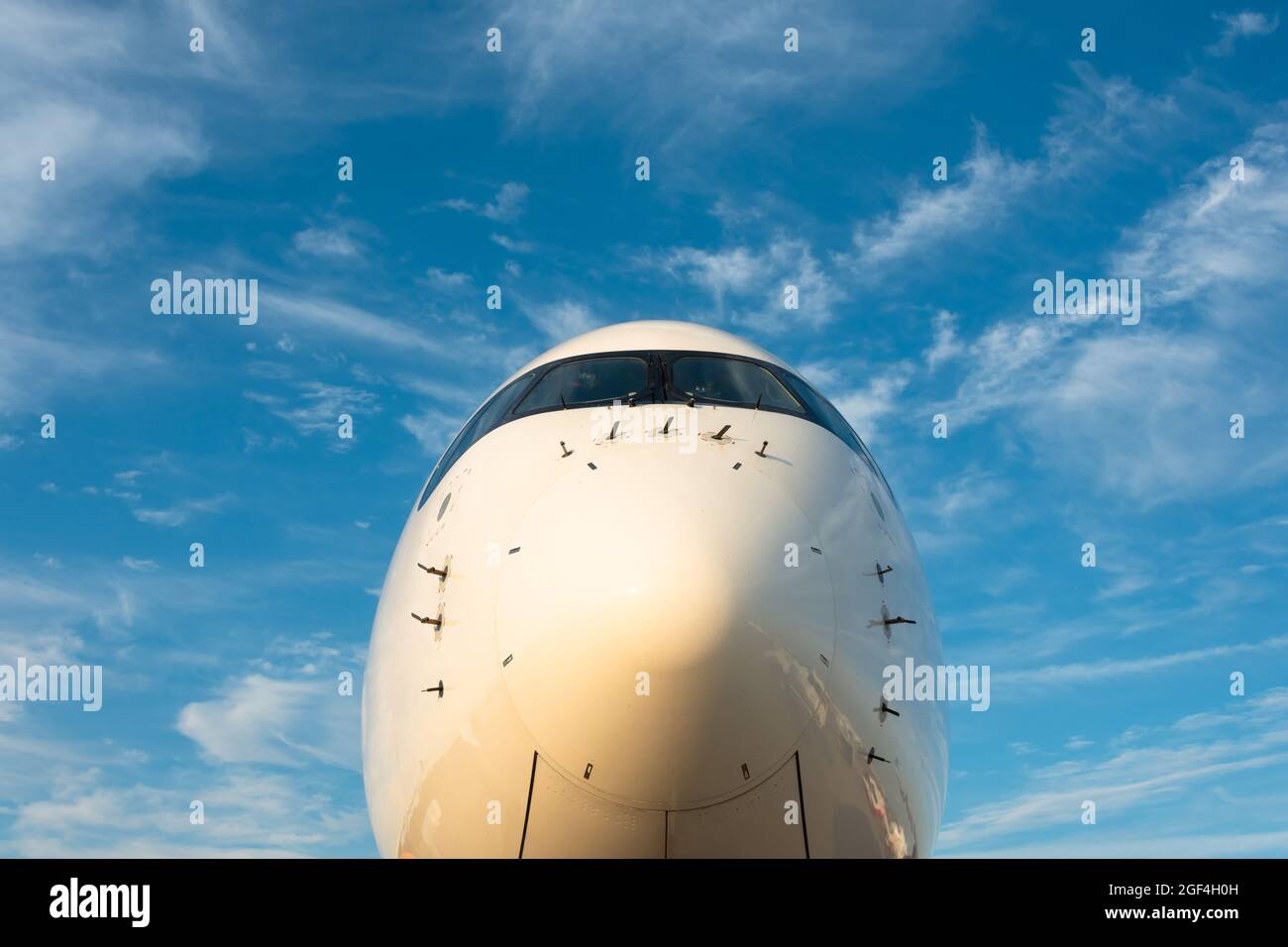 Airplane view from the front cockpit windshield fuselage at sunset ...