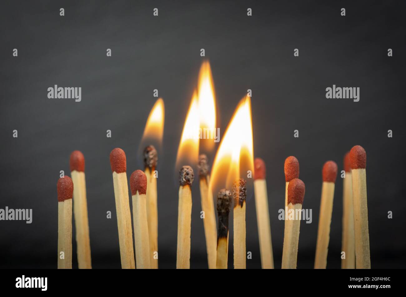 Group of burning matches against a dark background Stock Photo - Alamy