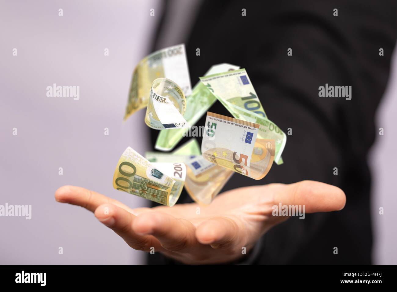 Businessman holding digital floating Euro banknotes Stock Photo - Alamy