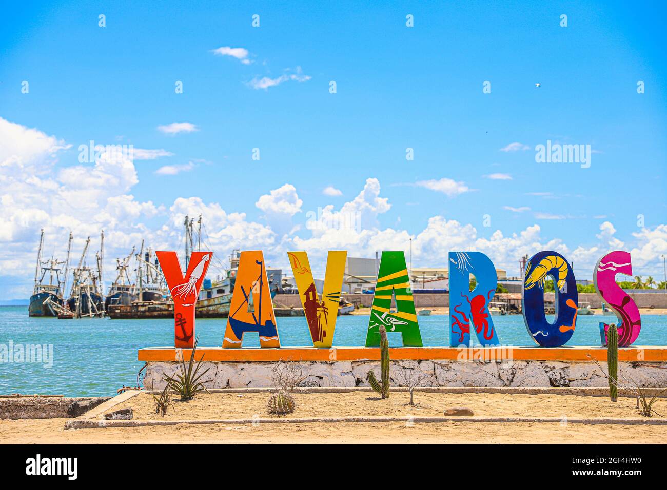 Monumental colored letters and fishing boats in the Yavaros bay sea ...