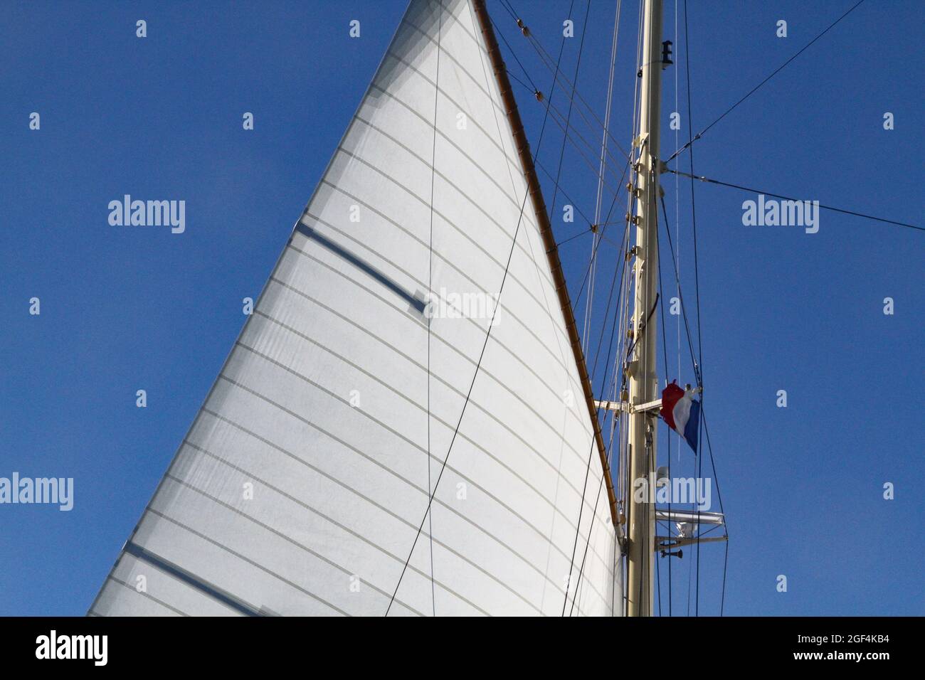 Low angle shot of sailing ship masts under the sunlight and a blue sky ...