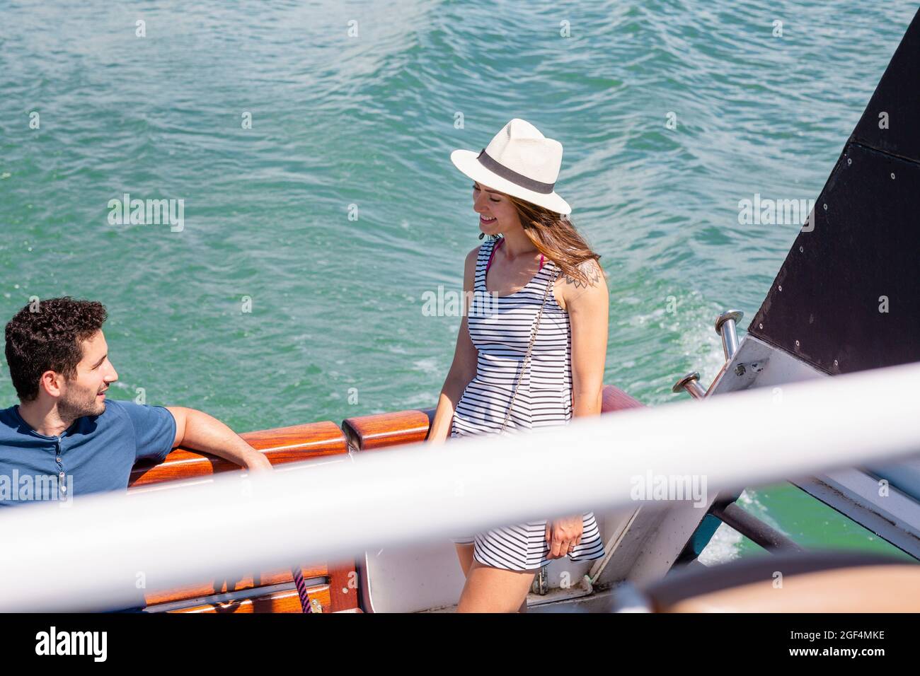 Girlfriend talking with boyfriend at ferry boat on sunny day Stock ...