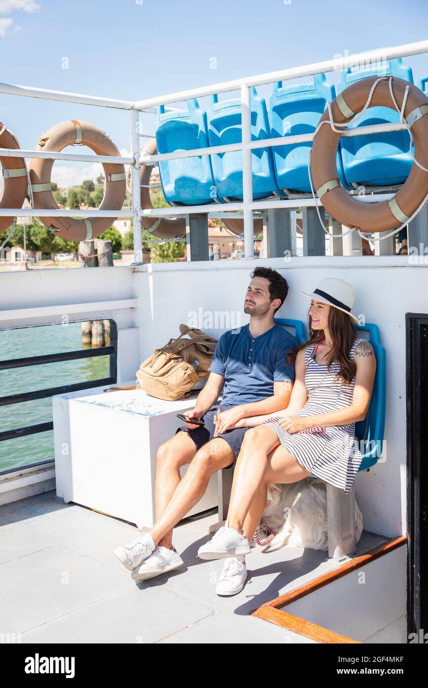 Smiling tourist couple sitting in passenger craft Stock Photo - Alamy