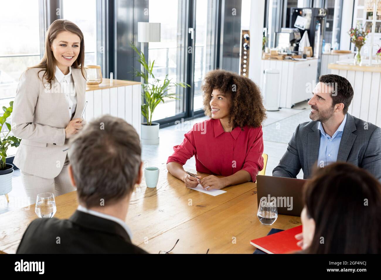 Female professional planning with colleague in meeting Stock Photo - Alamy