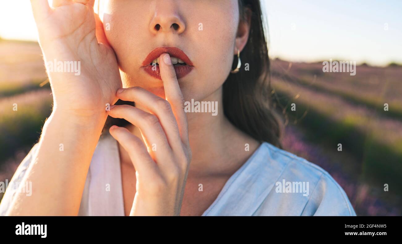 Women touching finger to lips hi-res stock photography and images - Alamy