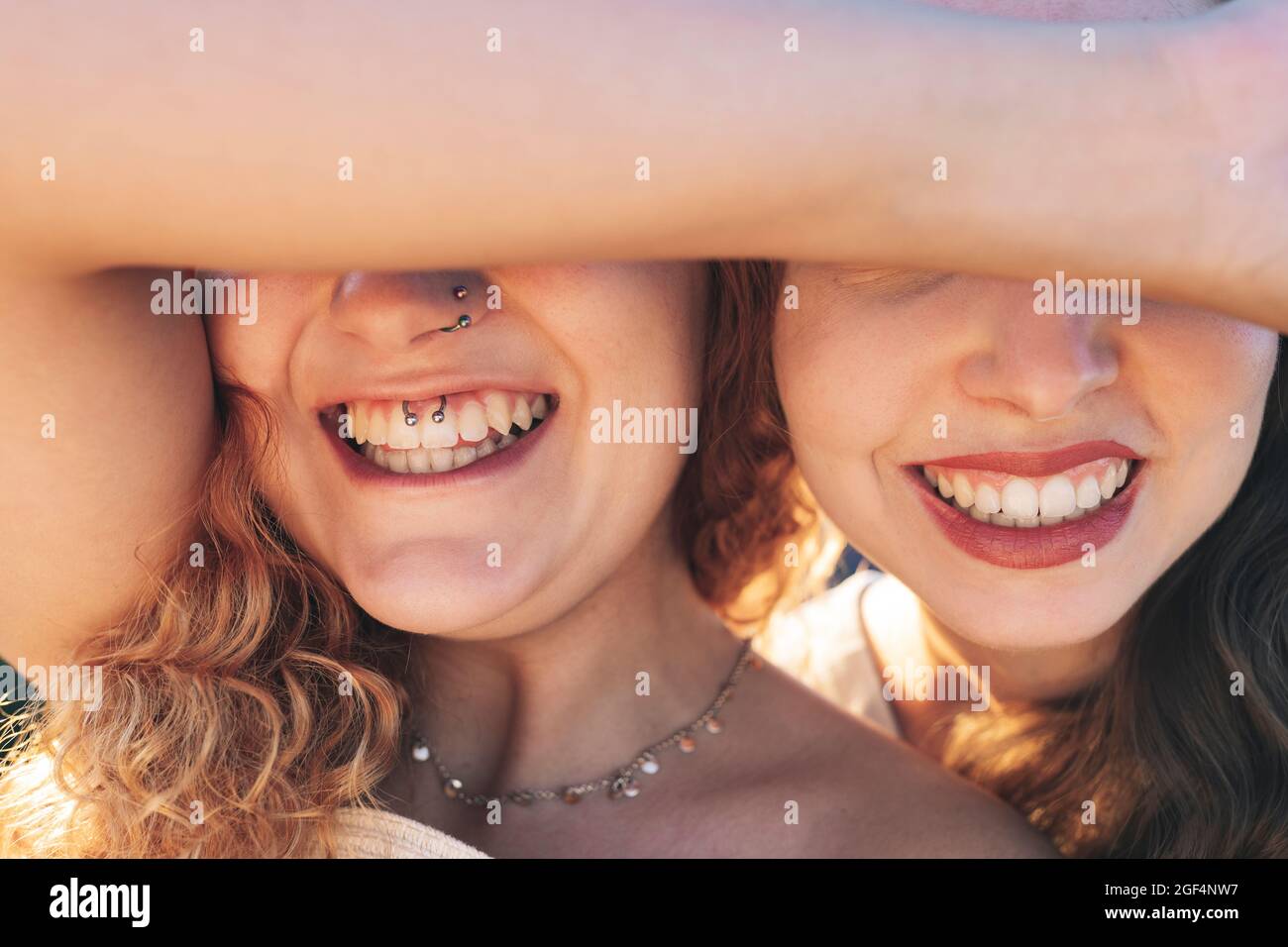 Happy young female friends covering eyes Stock Photo - Alamy