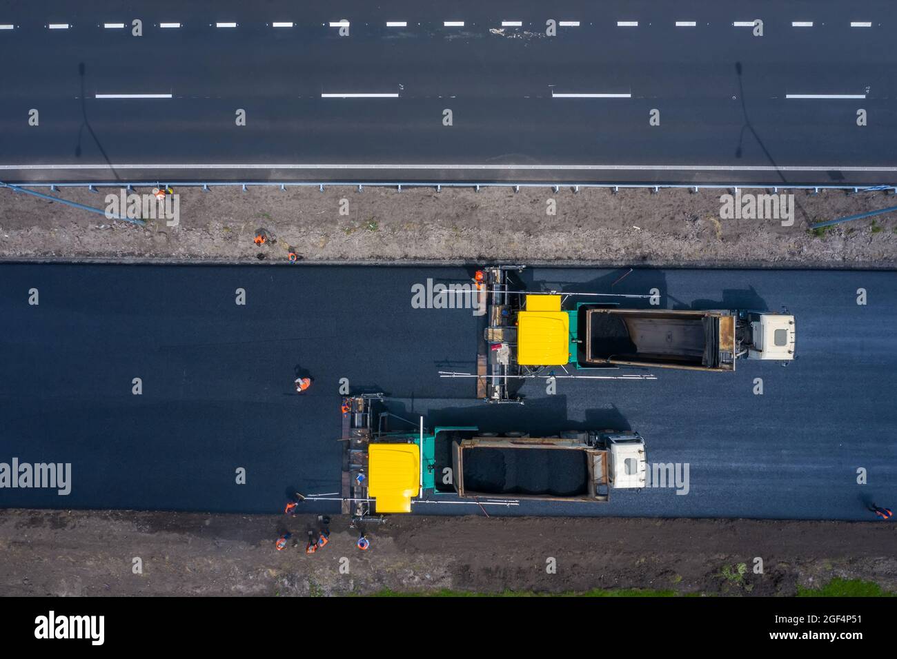 Asphalt paving paver machine new road construction aerial top view ...