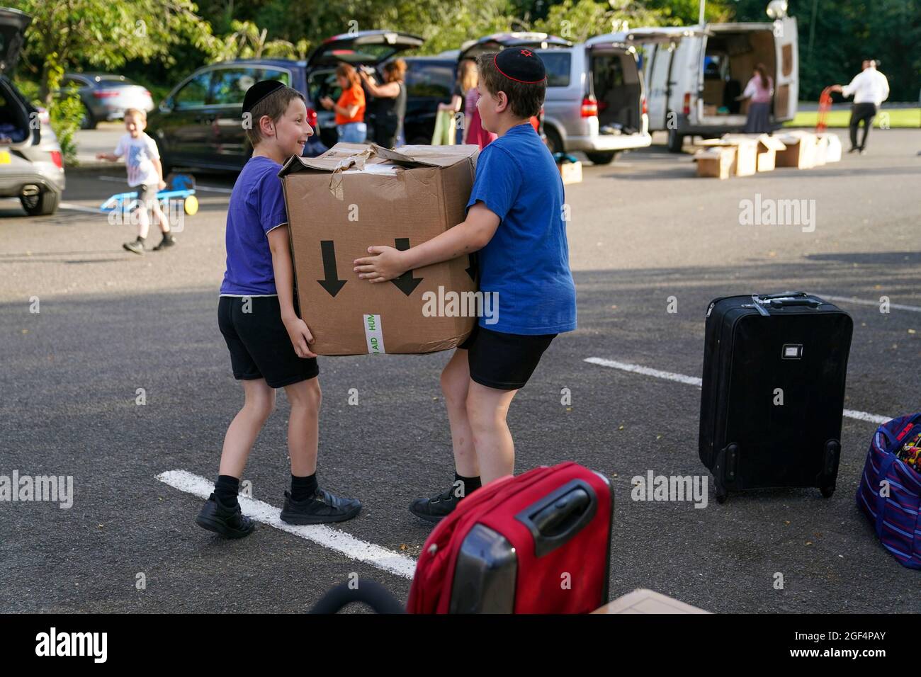 Members of the Jewish community in Watford prepare to deliver items, to ...