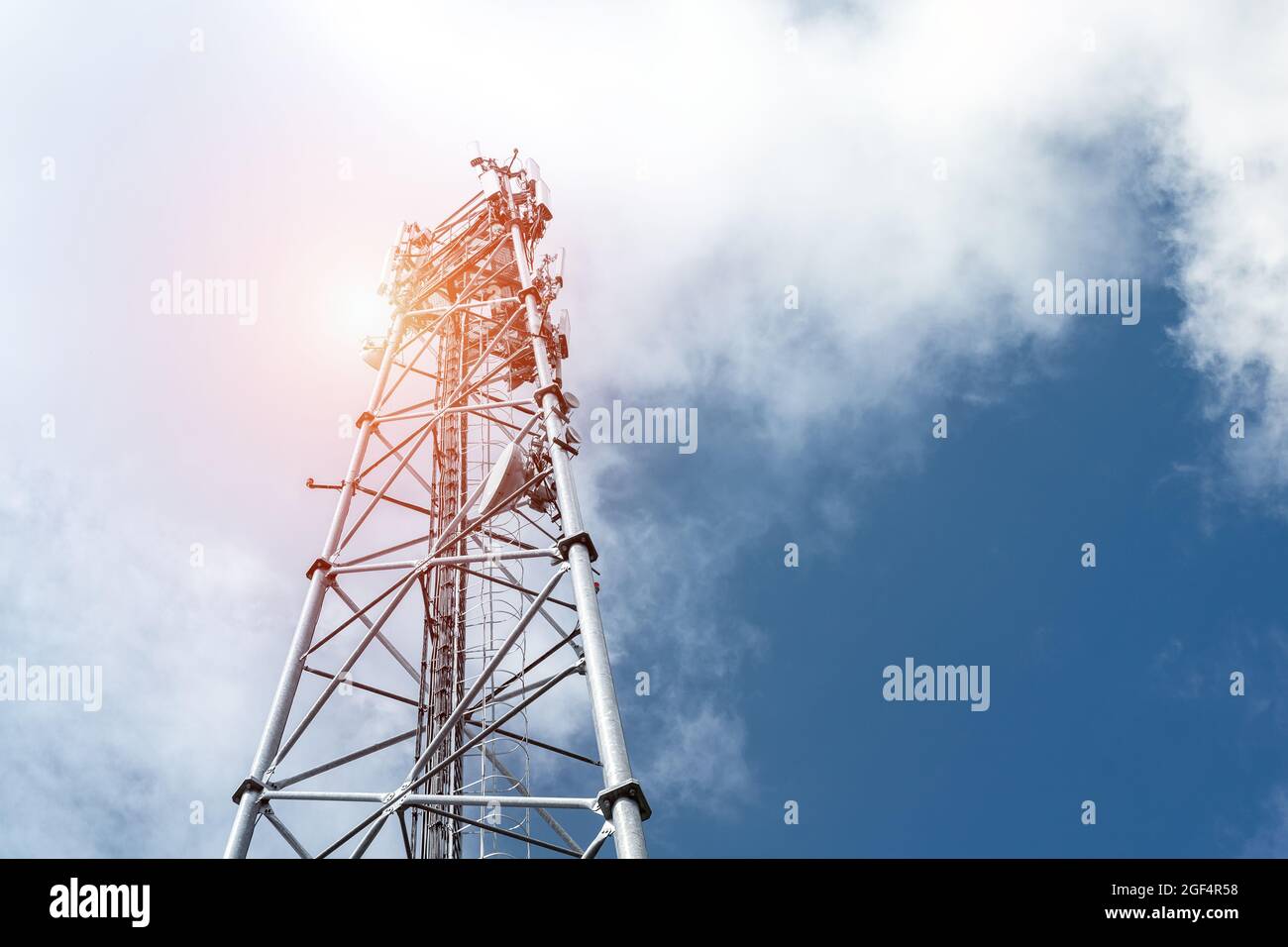 Bottom perspective pov of modern metal steel mobile 5g network wireless telecom tower against ...