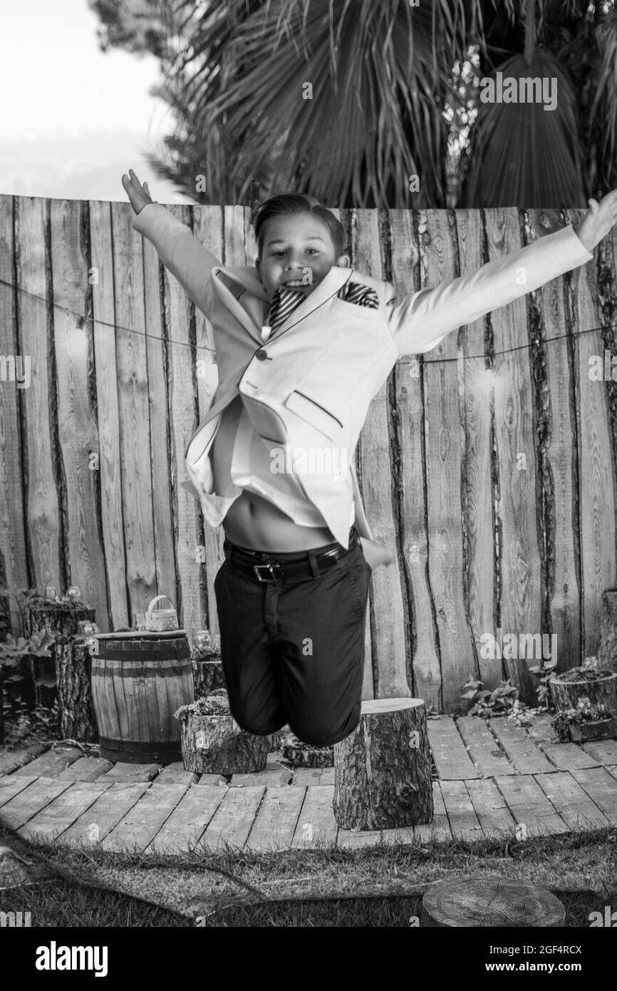 Vertical grayscale closeup of a young boy jumping Stock Photo - Alamy