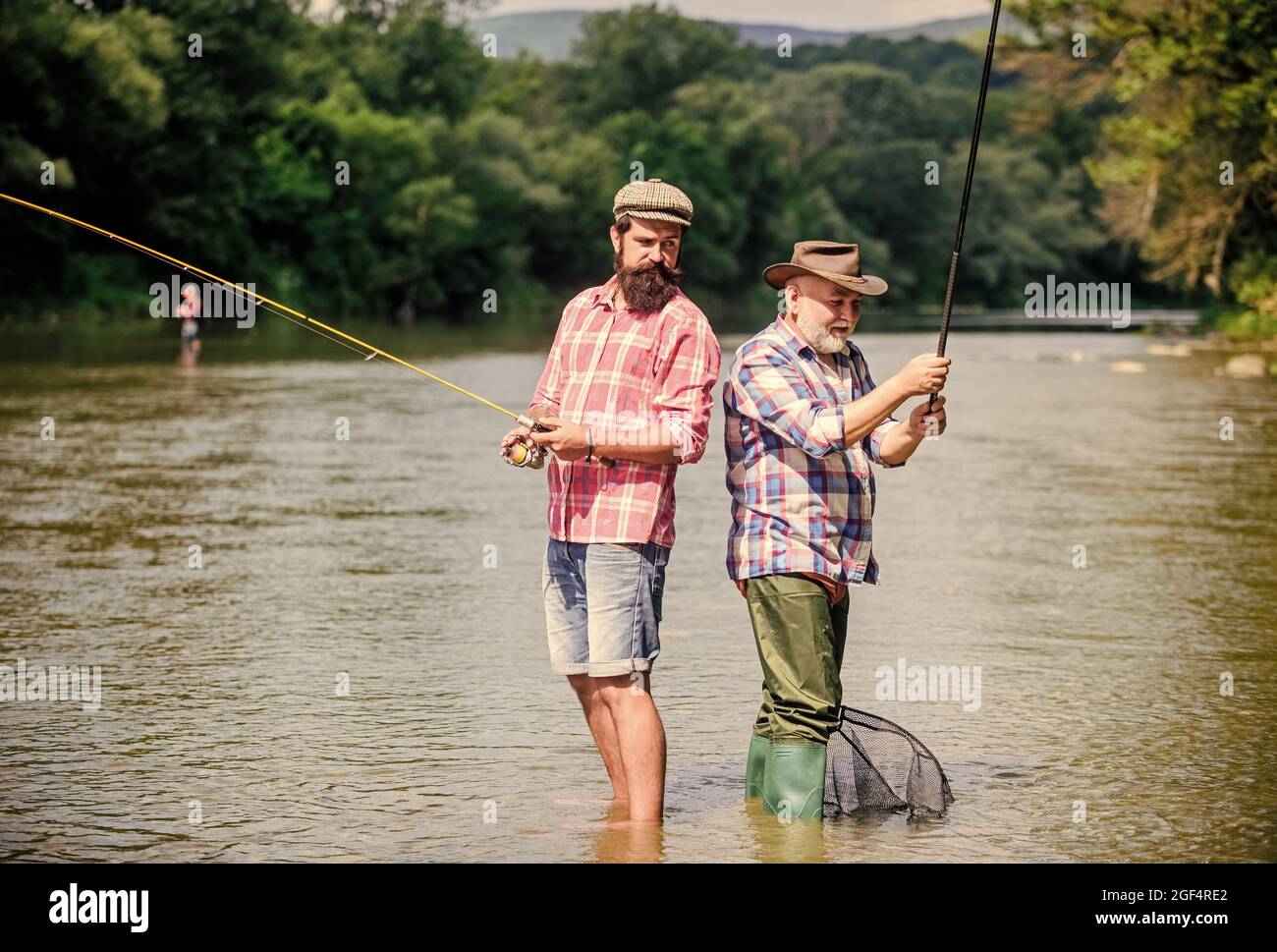 male friendship. family bonding. two happy fisherman with fishing rod ...
