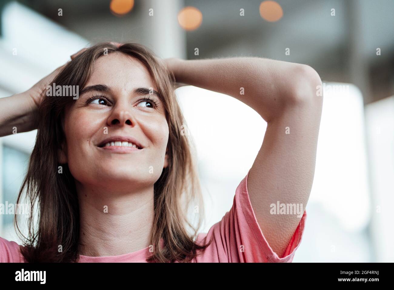 Young woman raising arms sitting hi-res stock photography and images ...