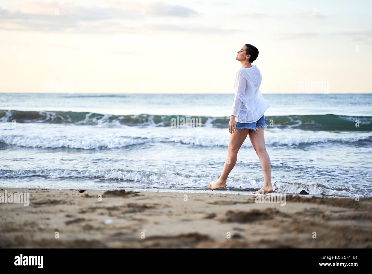 Female walking by sea hi-res stock photography and images - Alamy
