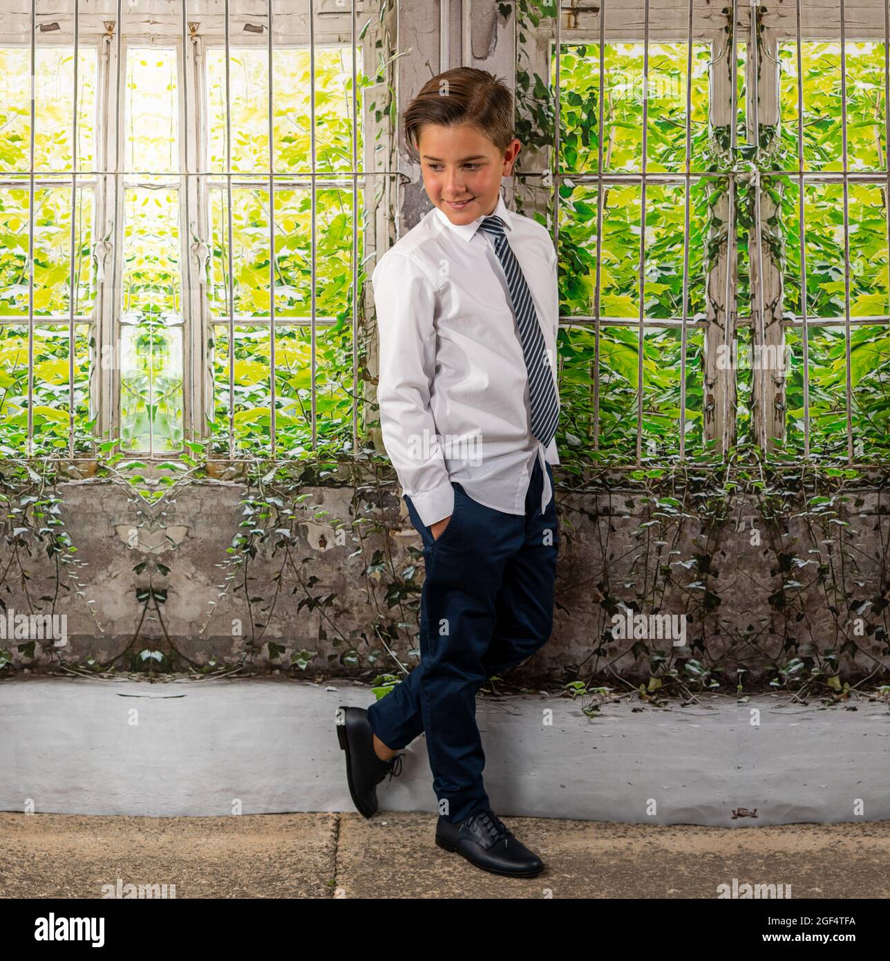 Closeup of a young boy in a white shirt with a tie posing indoors Stock ...