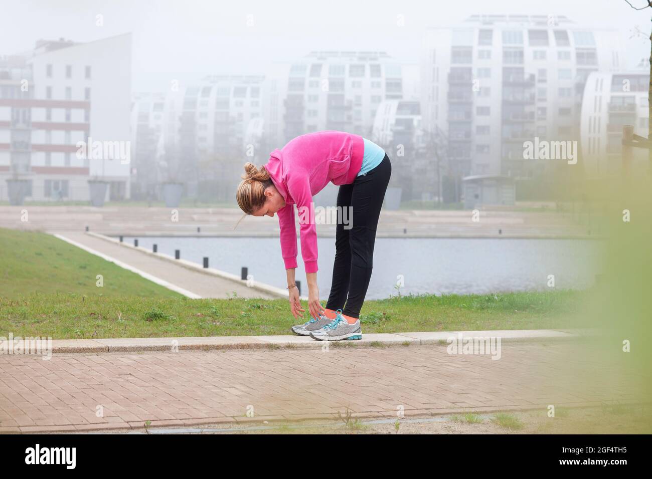 Side view bending down hi-res stock photography and images - Alamy
