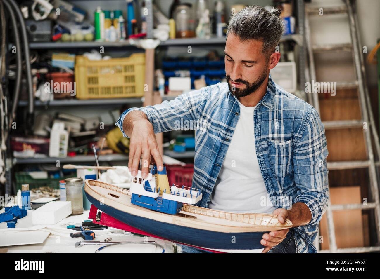 Male craftsperson building ship model at workshop Stock Photo - Alamy
