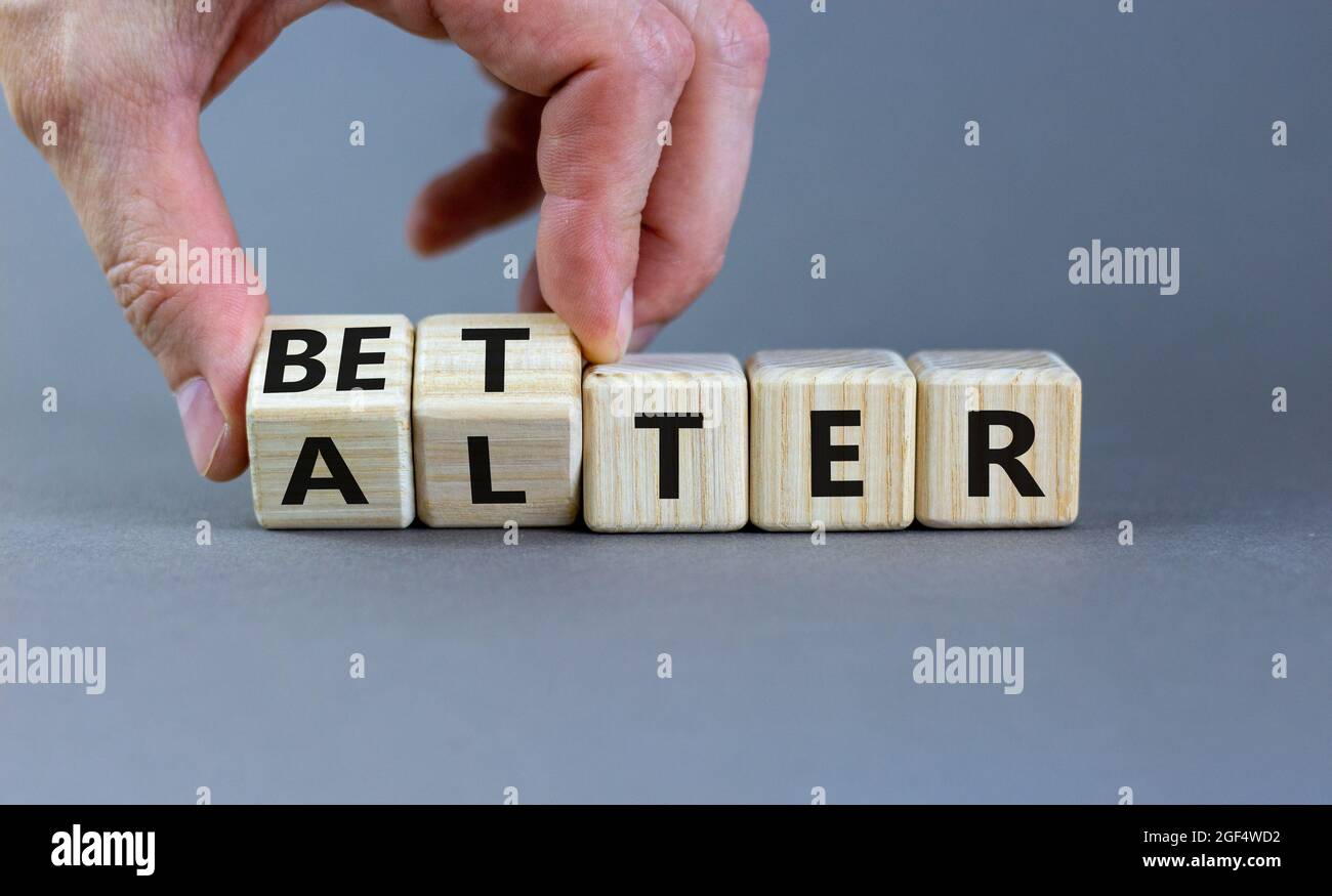 Alter or better symbol. Businessman turns wooden cubes and changes the ...