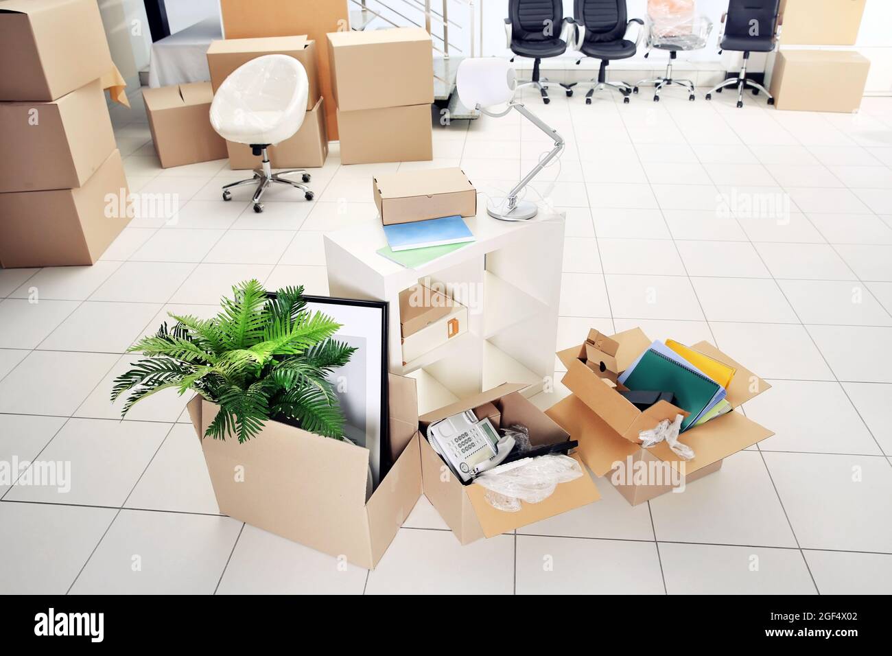 Move concept. Unpacking cardboard boxes in a new office Stock Photo - Alamy