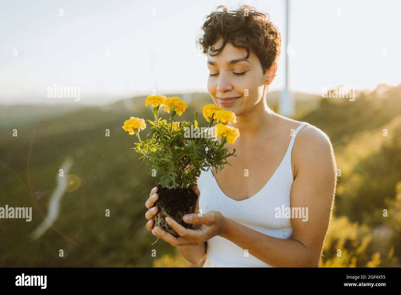 Woman smelling yellow flower hi-res stock photography and images - Alamy
