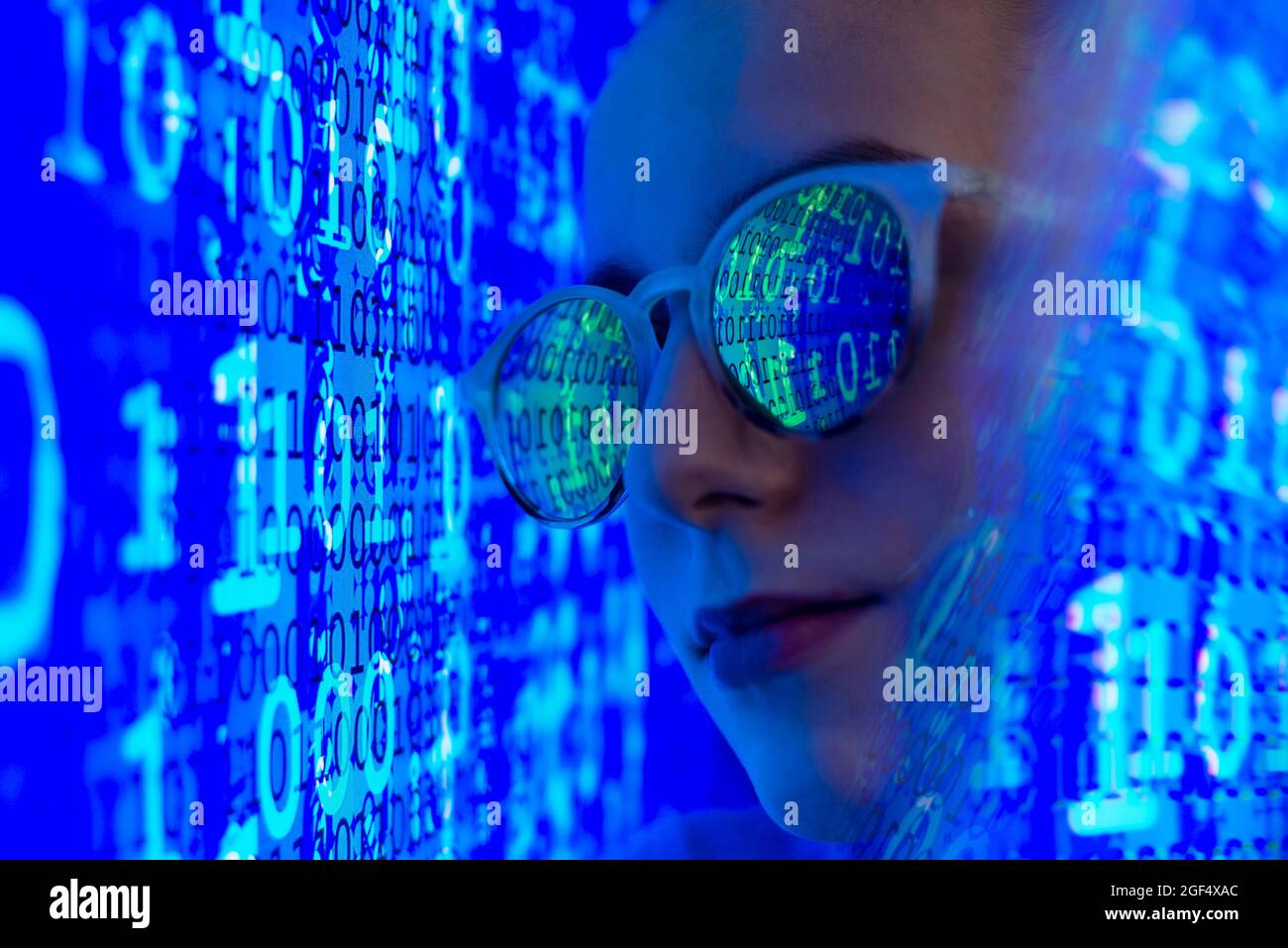 Female computer criminal checking binary code on computer device Stock ...