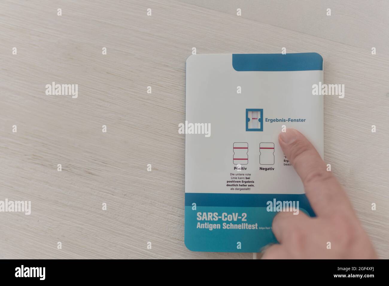 Finger pointing at COVID-19 rapid test results Stock Photo - Alamy