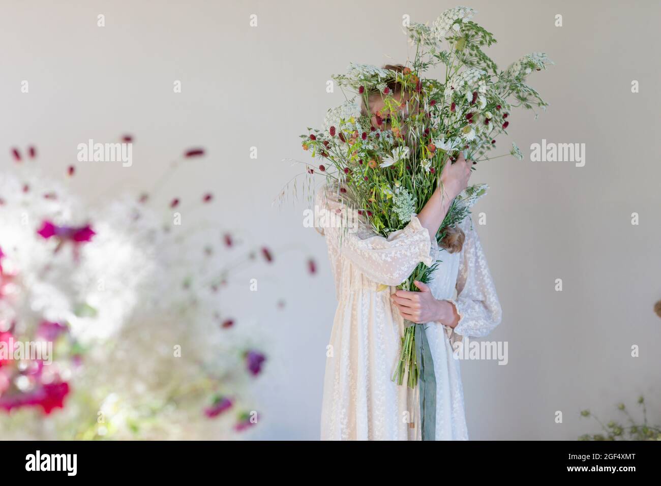Woman covering face bouquet hi-res stock photography and images - Alamy