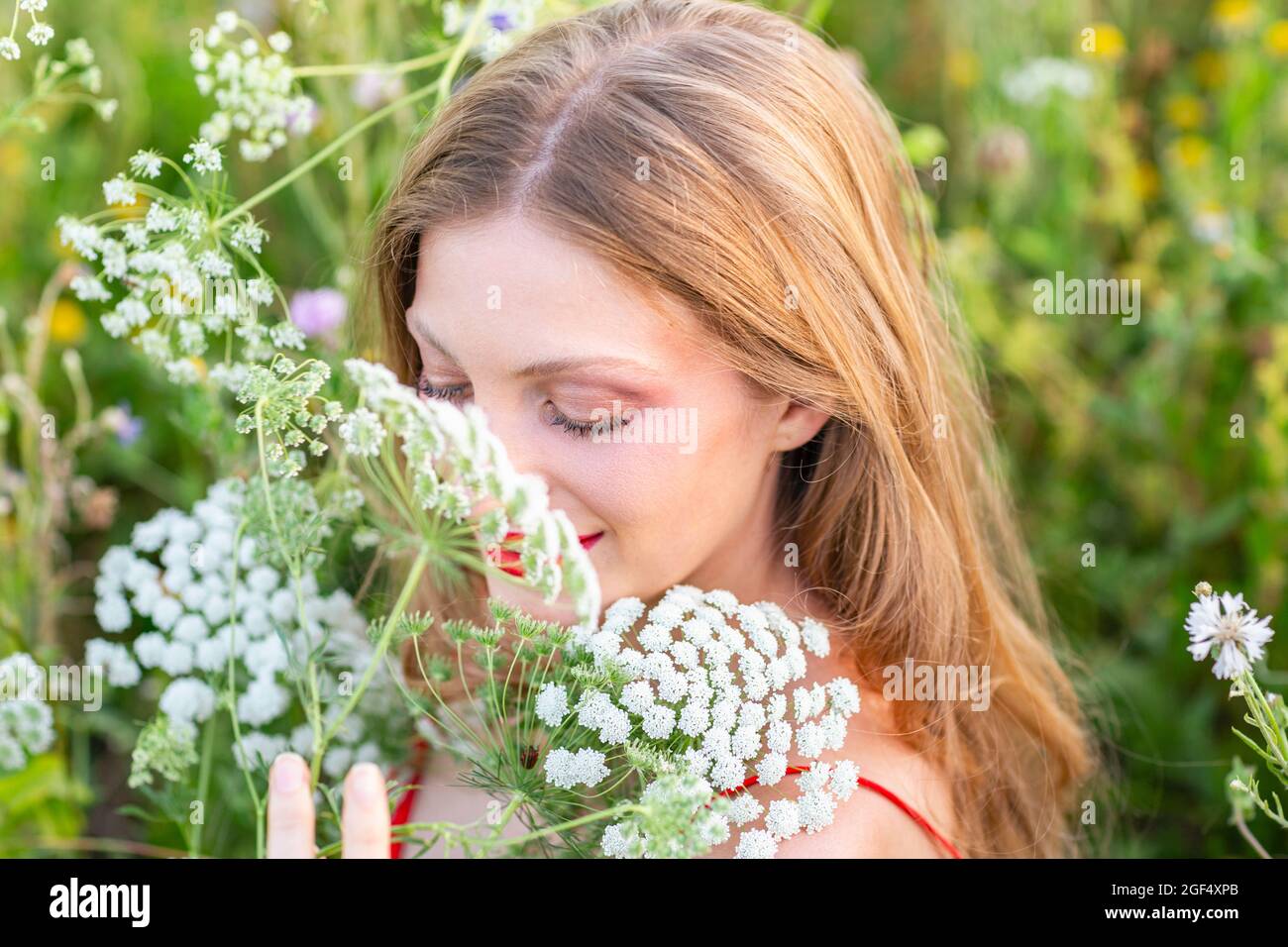 Beautiful woman smelling plant hi-res stock photography and images - Alamy