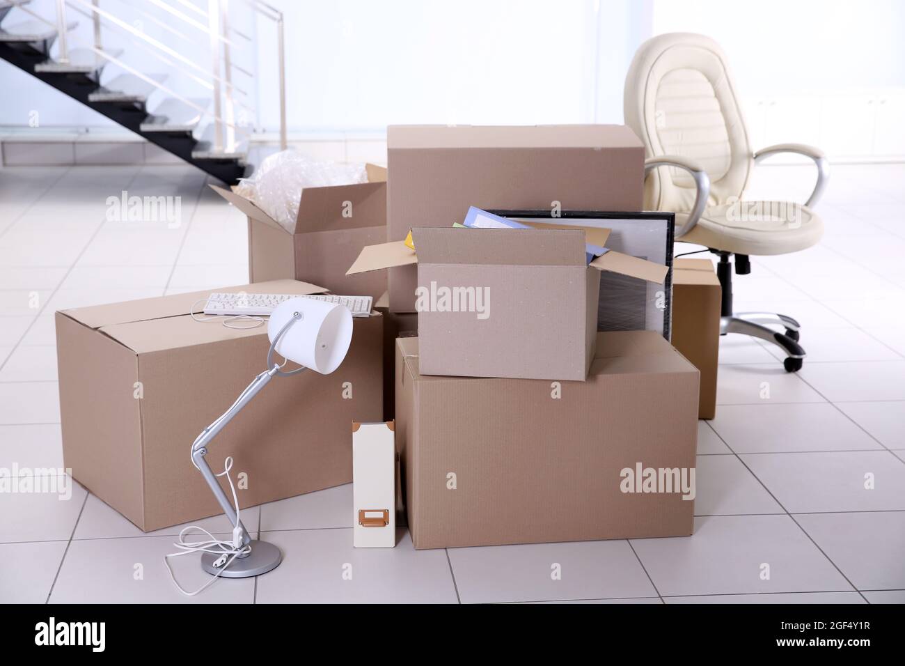 Move concept. Unpacking cardboard boxes in a new office Stock Photo - Alamy