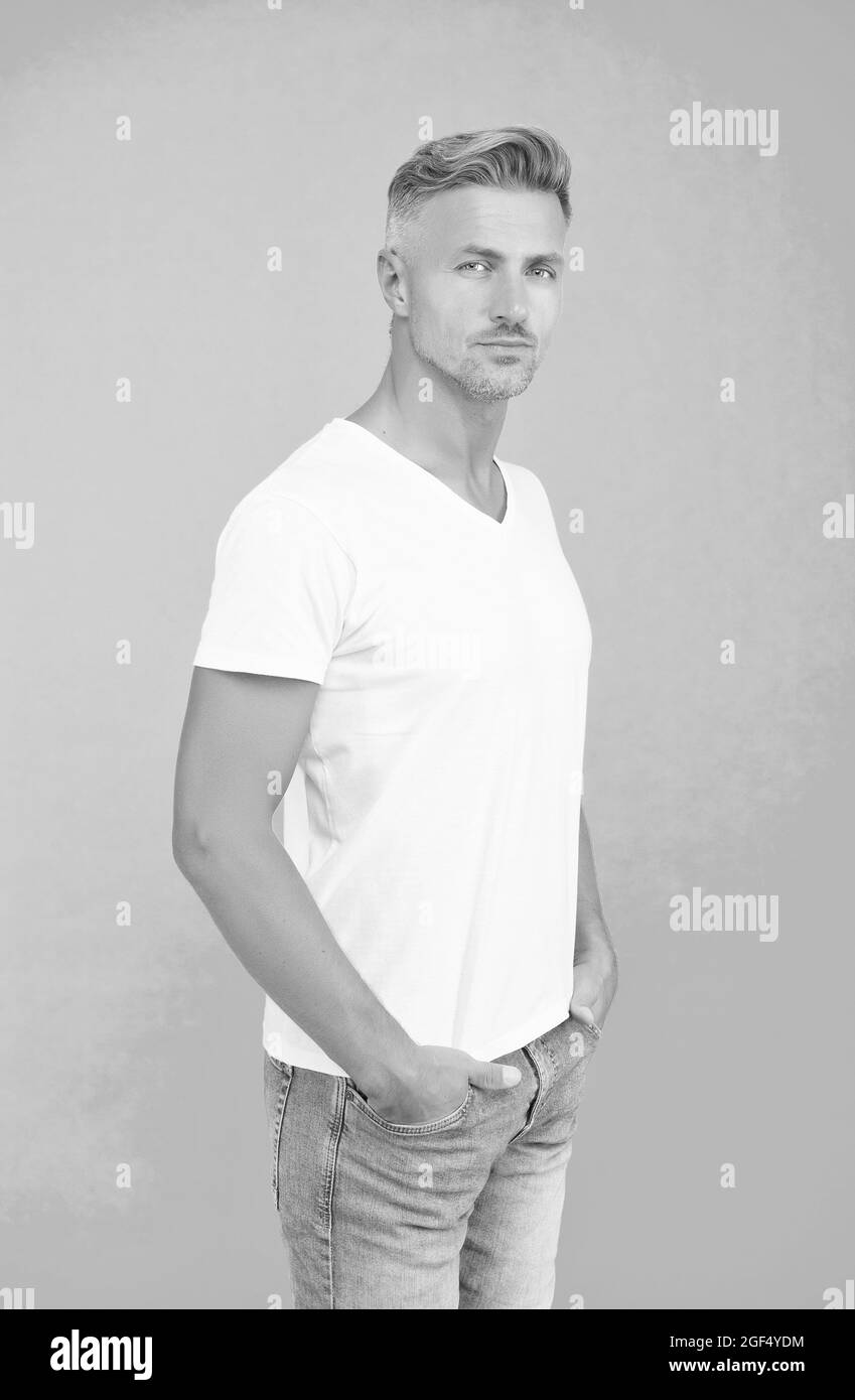 smiling guy with trendy hairstyle has colored graying hair and groomed ...