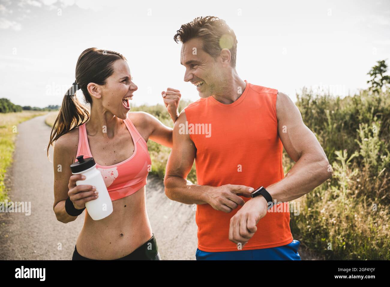 Woman shouting while cheering sportsman Stock Photo - Alamy