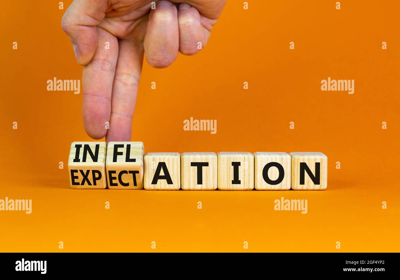 Inflation and expectation symbol. Businessman turns cubes, changes the ...
