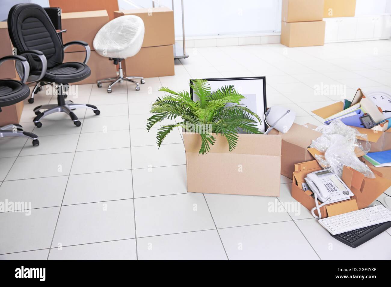 Move concept. Unpacking cardboard boxes in a new office Stock Photo - Alamy
