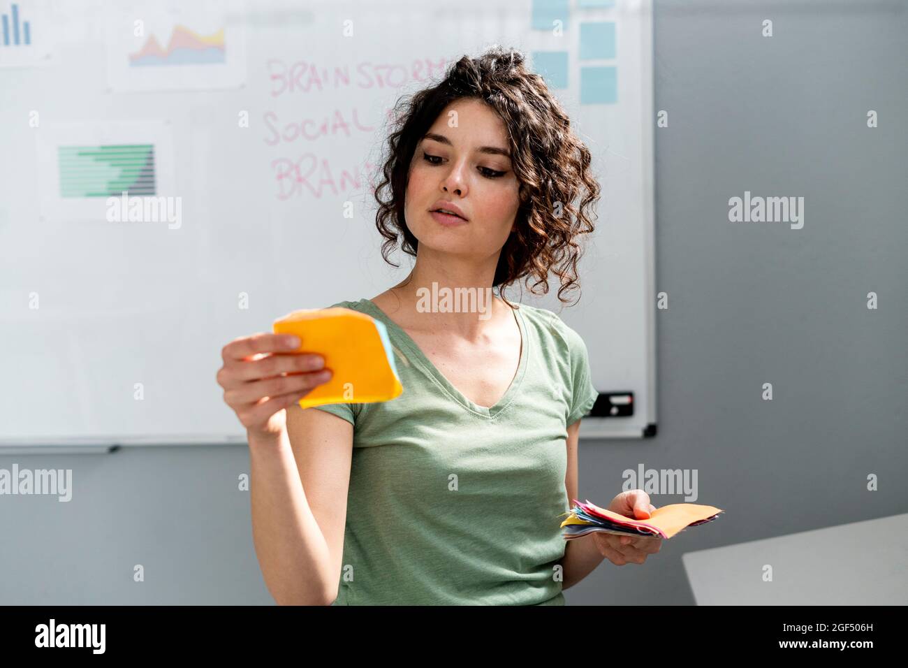 Female professional checking fabric swatch in office Stock Photo - Alamy