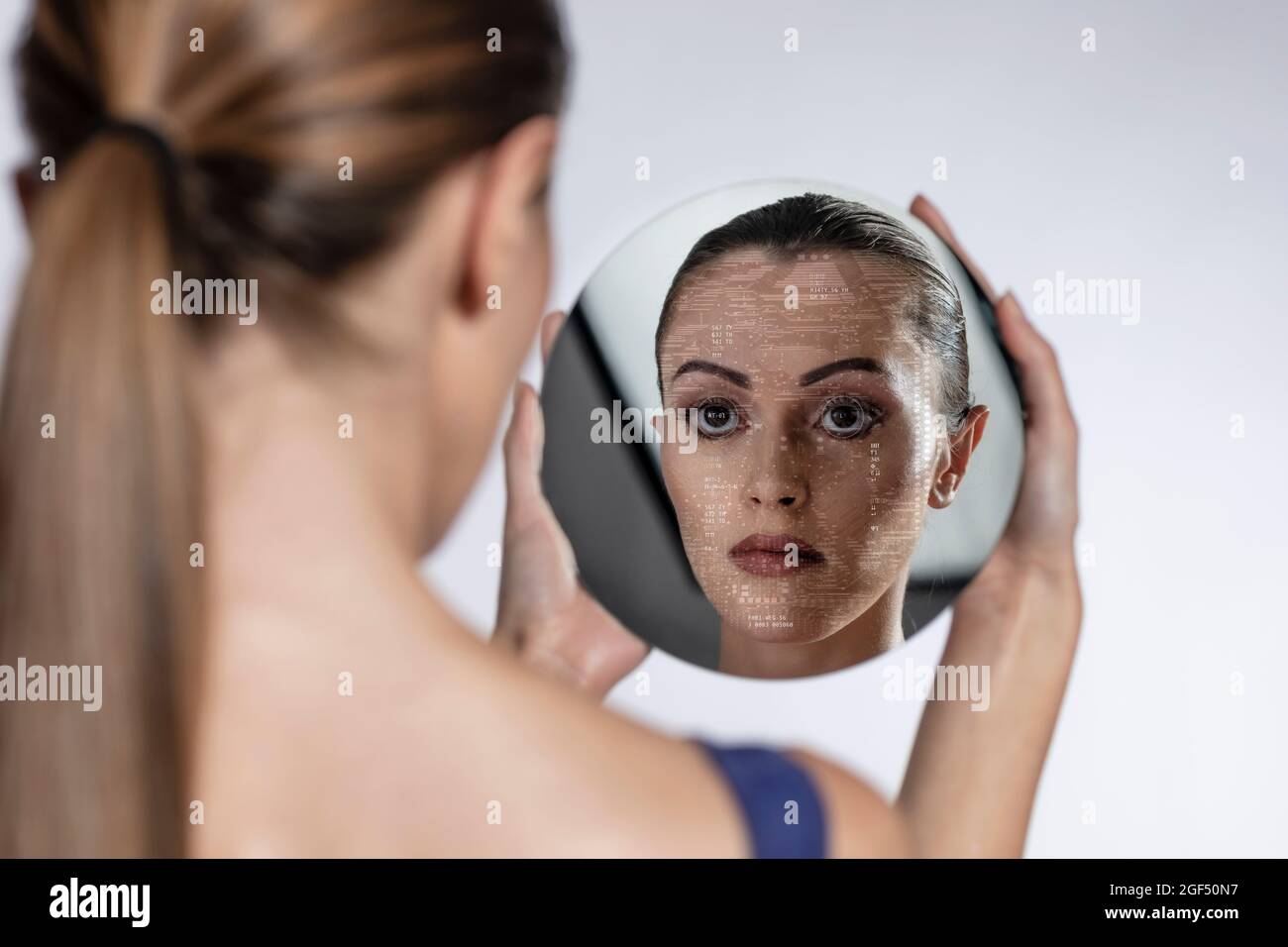 Female robot looking at mirror reflection over white background Stock ...