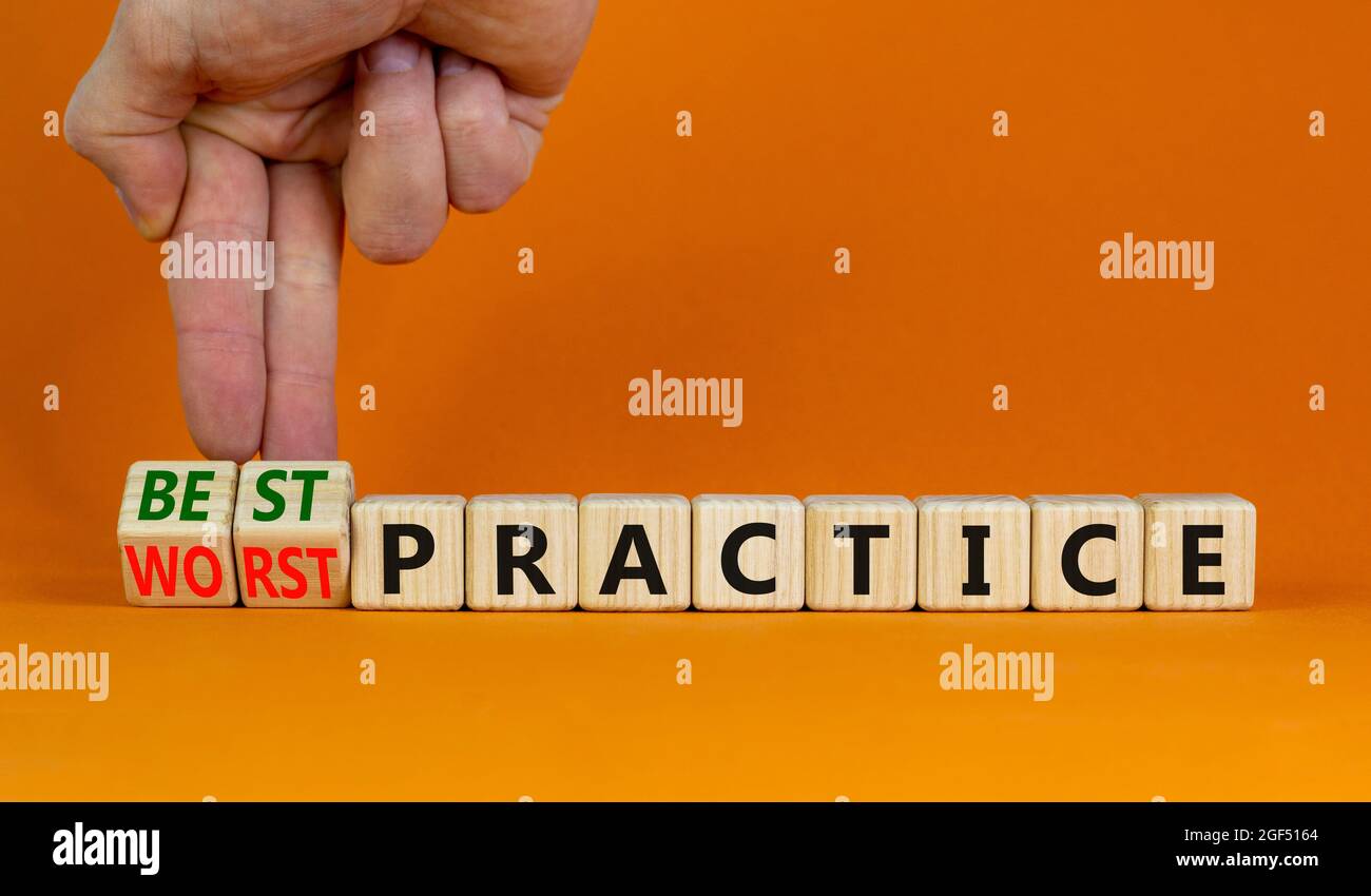 Best or worst practice symbol. Businessman turns wooden cubes and ...