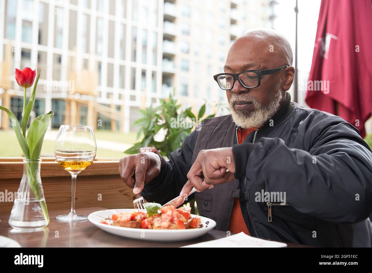 Man eating food at restaurant Stock Photo - Alamy