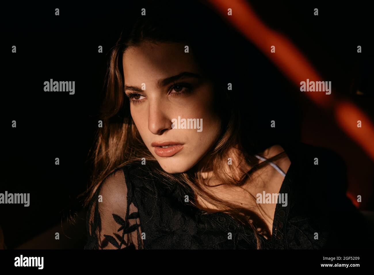 Beautiful young woman with sunlight on face Stock Photo - Alamy
